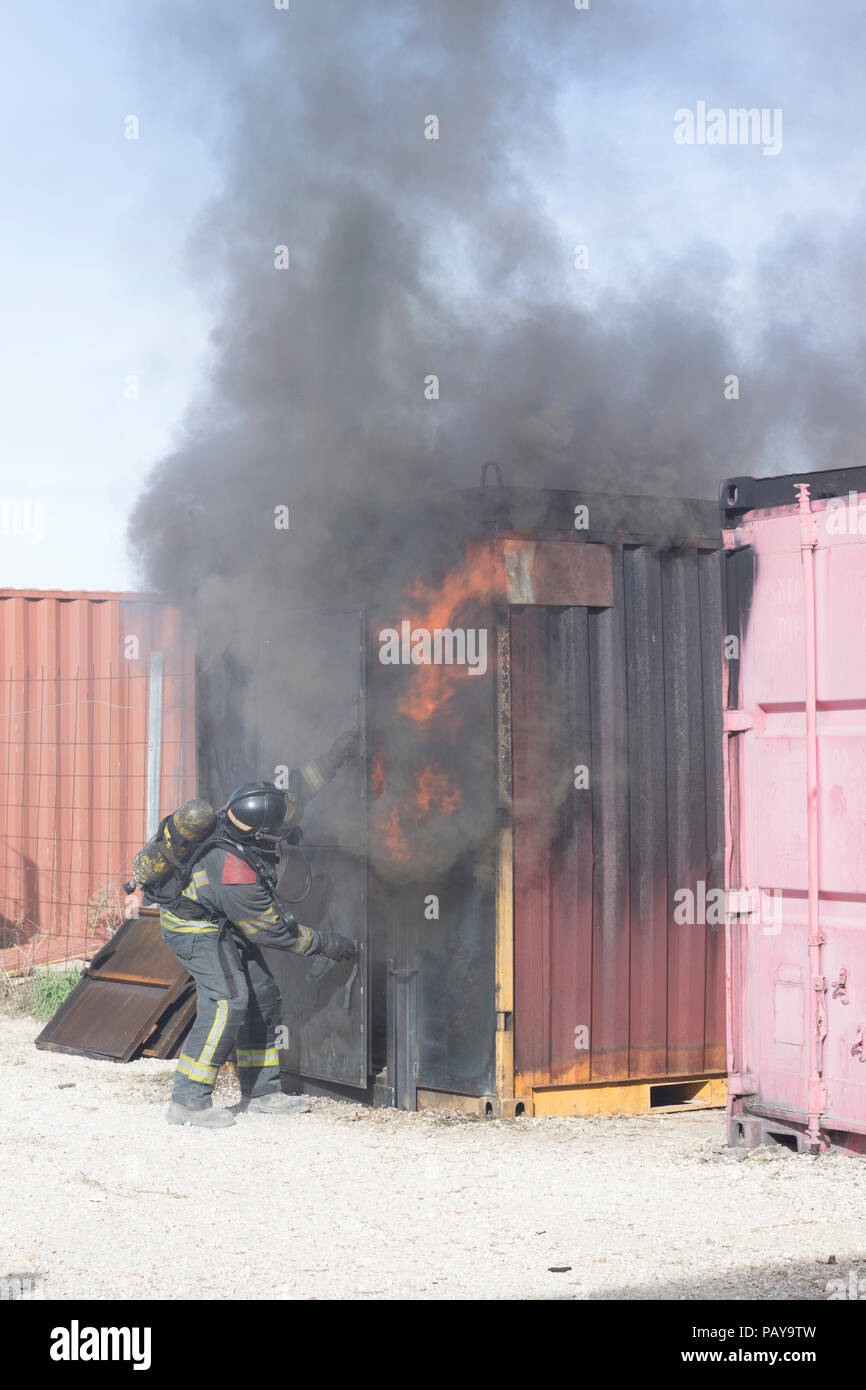 Firefighter putting out fire training station extinguisher backdraft ...