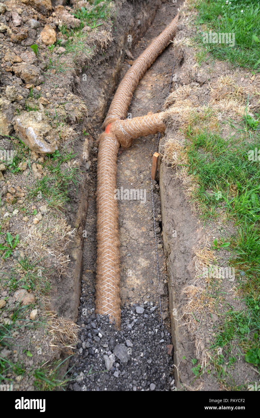 Drainage pipe in trench near farm Stock Photo - Alamy