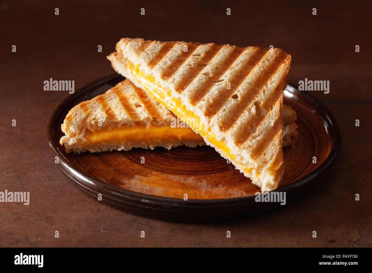 grilled cheese sandwich on rustic brown background Stock Photo - Alamy