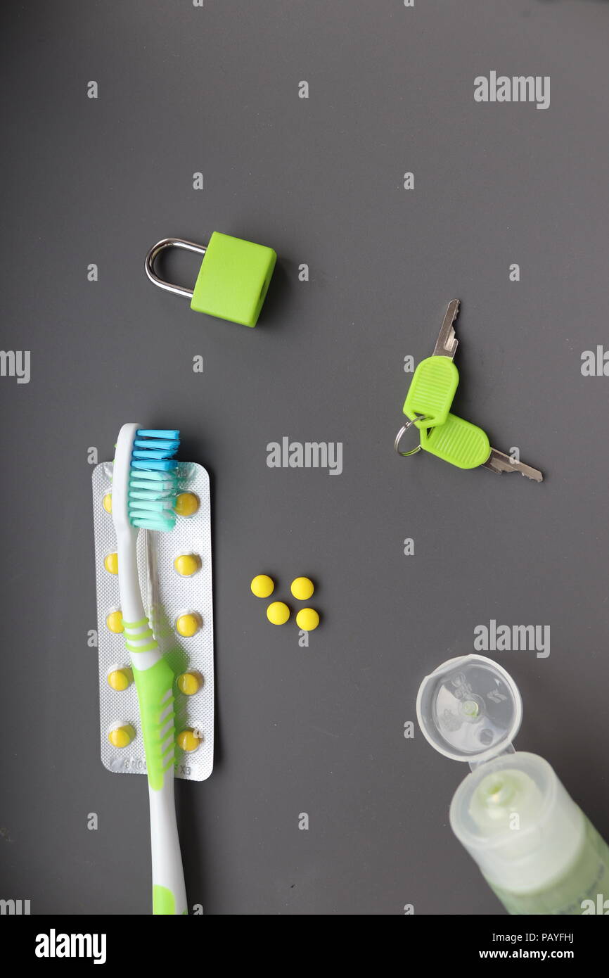 Travel essentials on a plain background.creams, tablets, floss,bottles ...