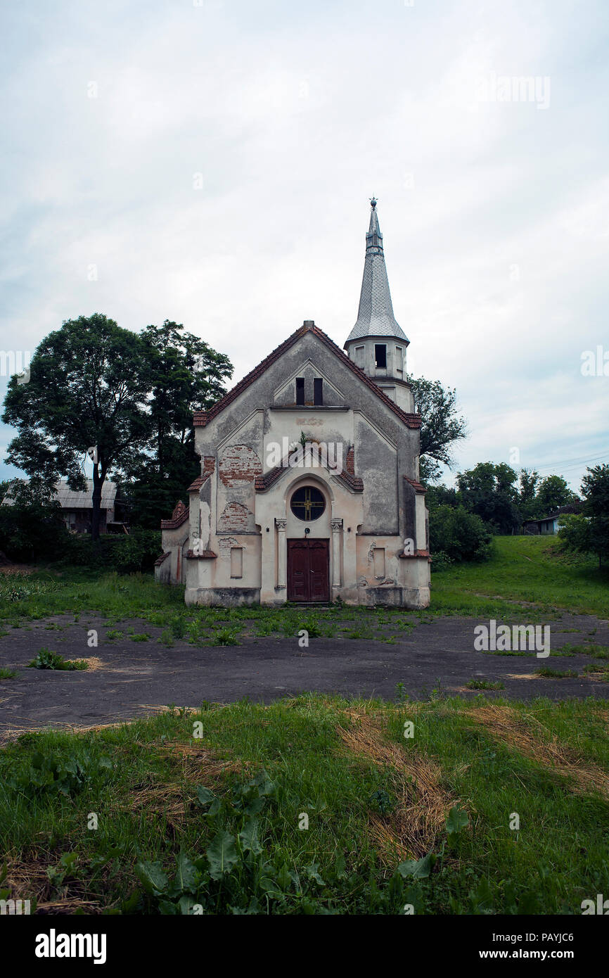 Summer rural landscape with old abandoned church in evening. Small ...