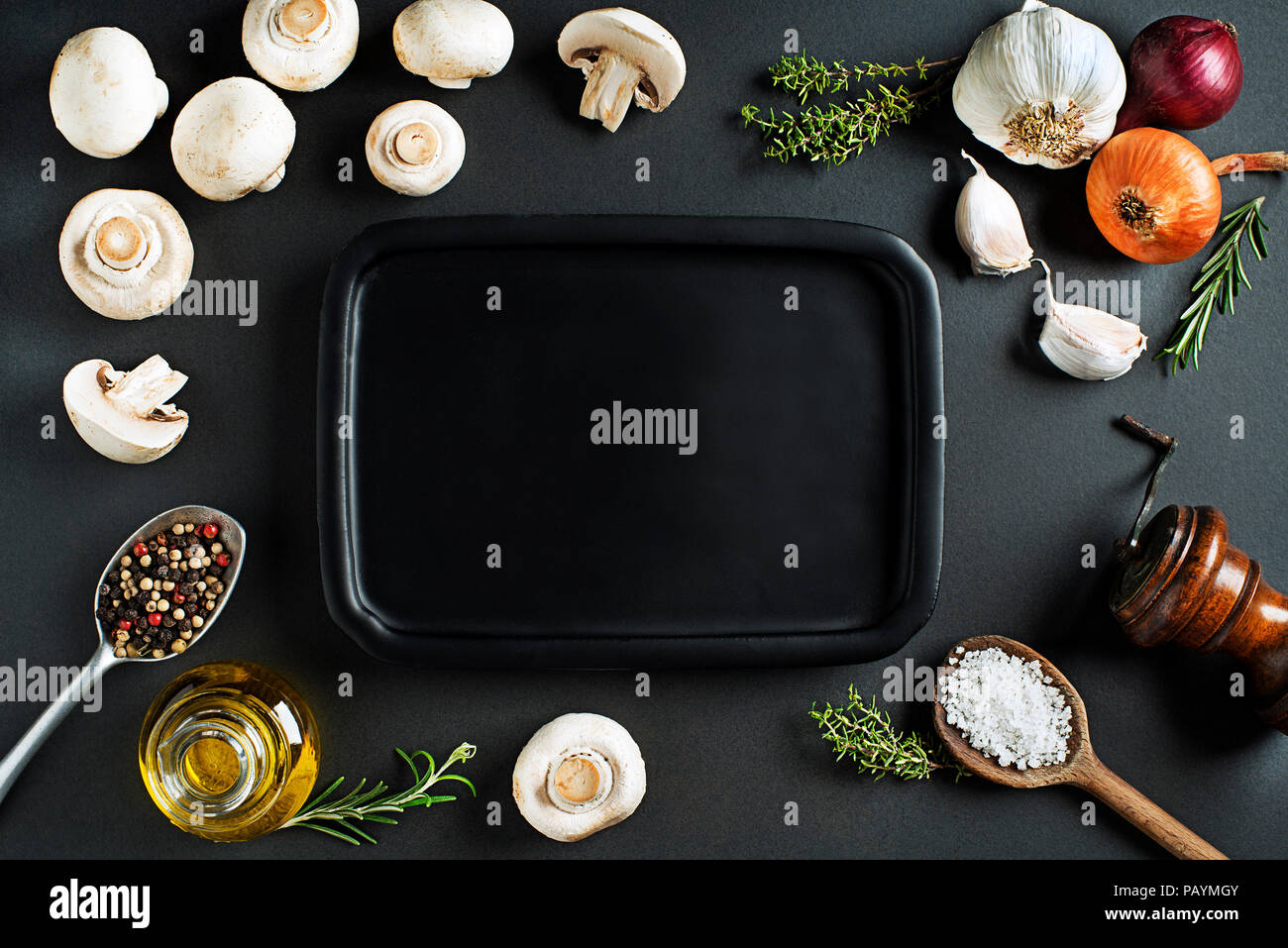 Mushrooms champignons with fresh ingredients on black background Stock ...