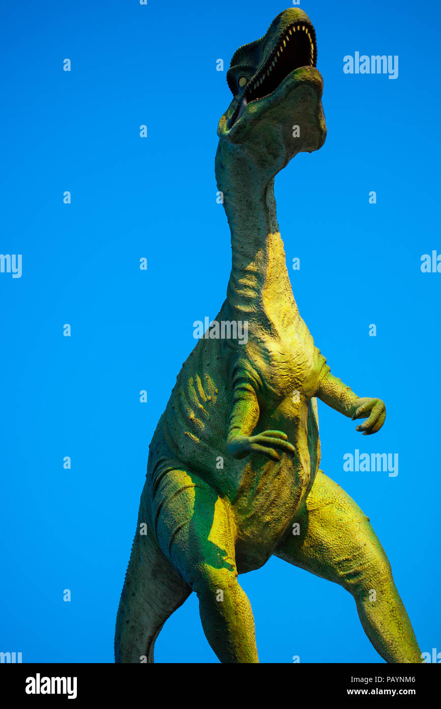 Model of Velociraptor roaring against blue sky Stock Photo - Alamy