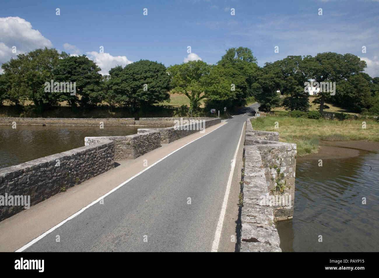 The narrow stone walled bridge carrying A4075 over inlet of Milford ...