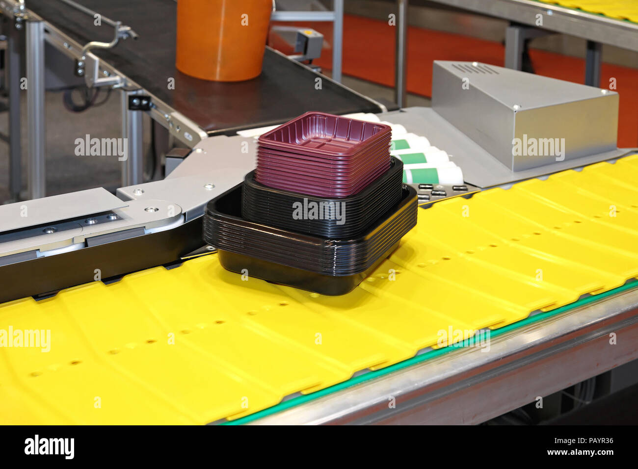 Yellow conveyor belt transport system in factory Stock Photo - Alamy