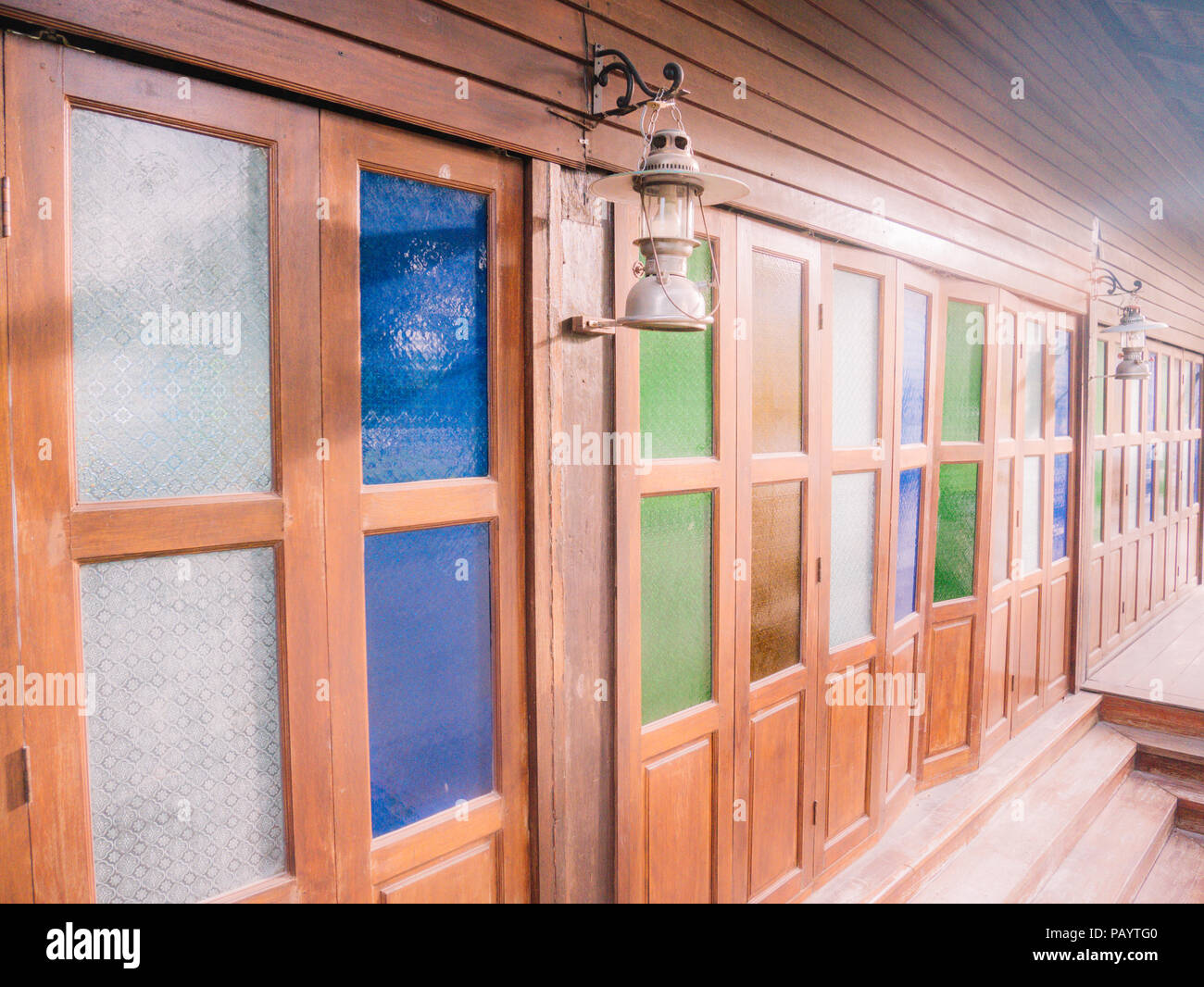 Beautiful variety color wooden windows at wooden home Stock Photo - Alamy