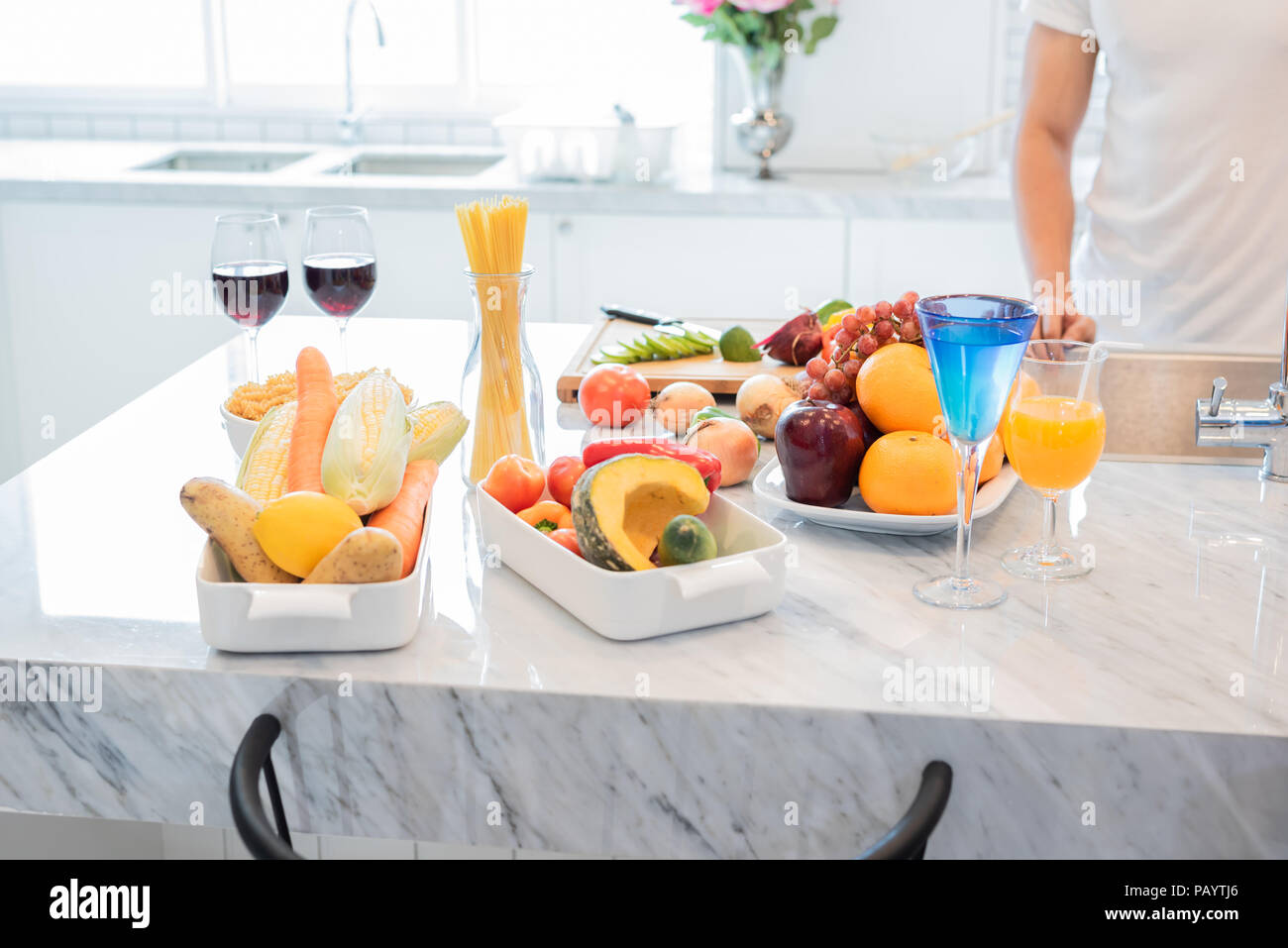 Man in the kitchen with preparing food for his wife coming home. People ...