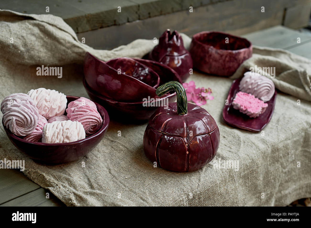 Set of handmade ceramics in purple on a piece of gray burlap.Rustic ...