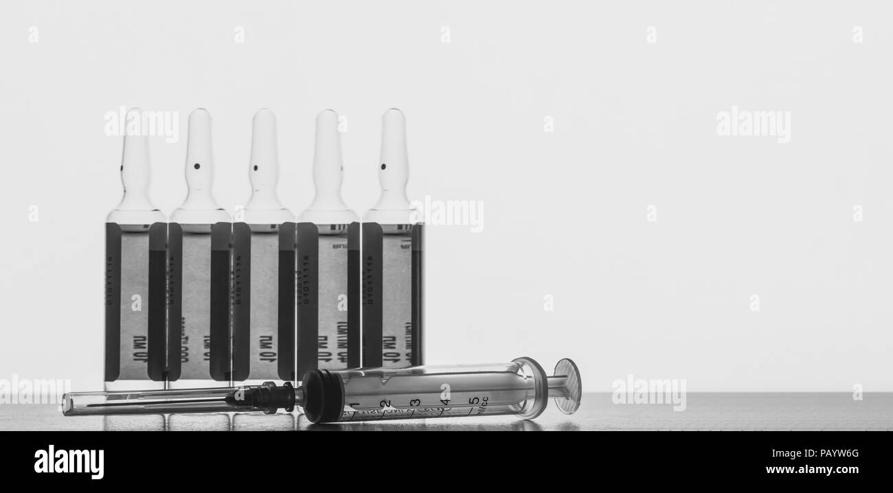 the ampoules with solution for injections and disposable syringe on ...
