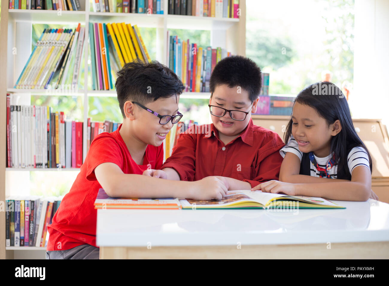 Asian young girl&boys reading books on desk and happiness feel at ...