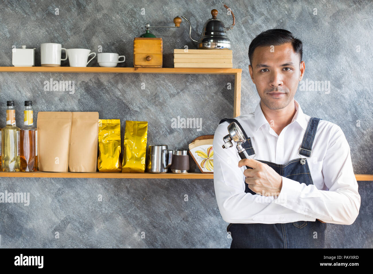 Portrait of handsome cheerful barista smiling and standing in coffee ...