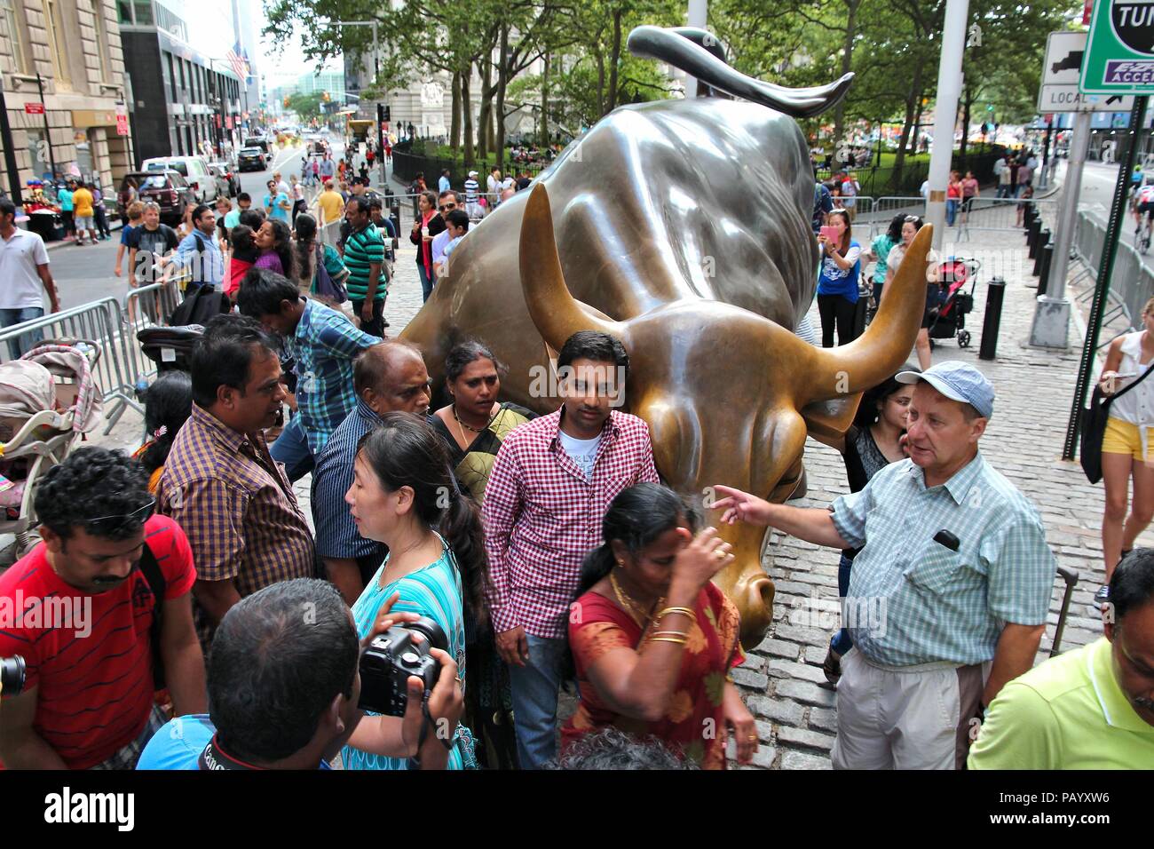 NEW YORK - JULY 4: People visit Charging Bull statue on July 4, 2013 in ...