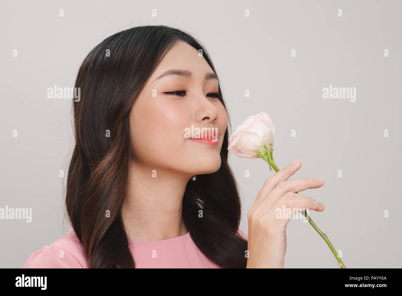 Beautiful young girl posing with a rose Stock Photo - Alamy
