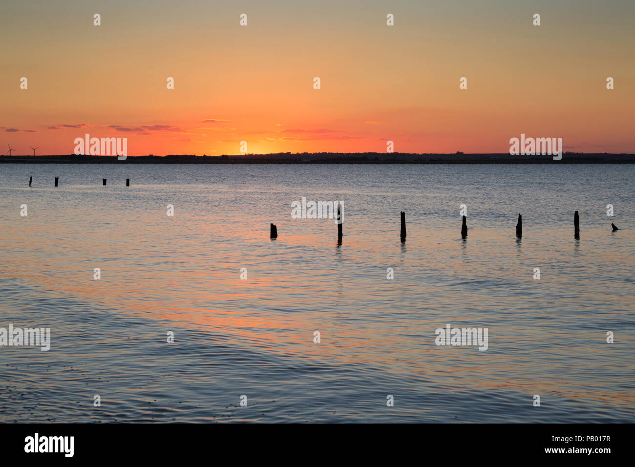 Vibrant orange sunset during the Solstice taken from Seasalter beach ...