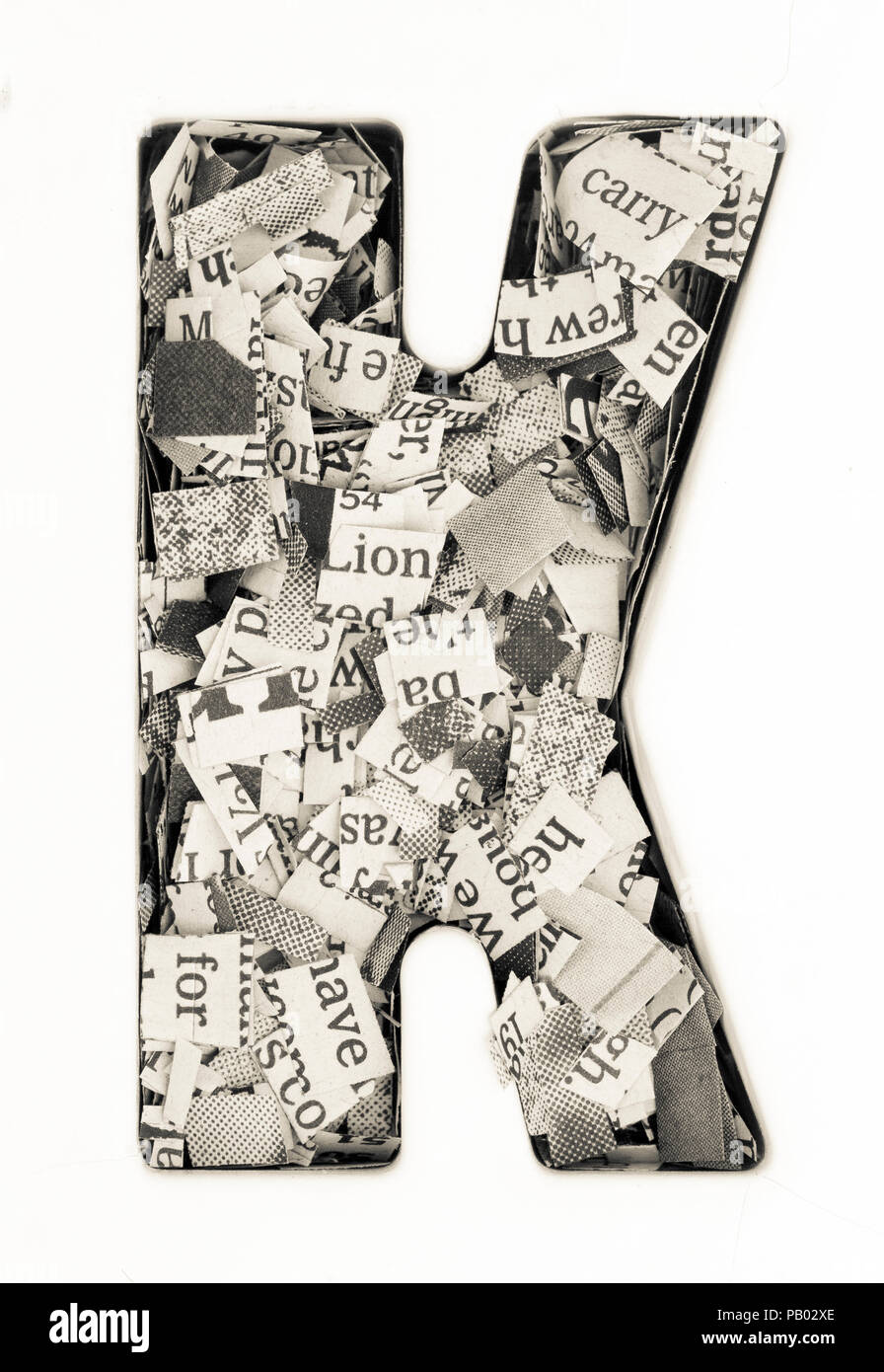 Capital letter made from cut up old newspaper Macro photography Stock ...