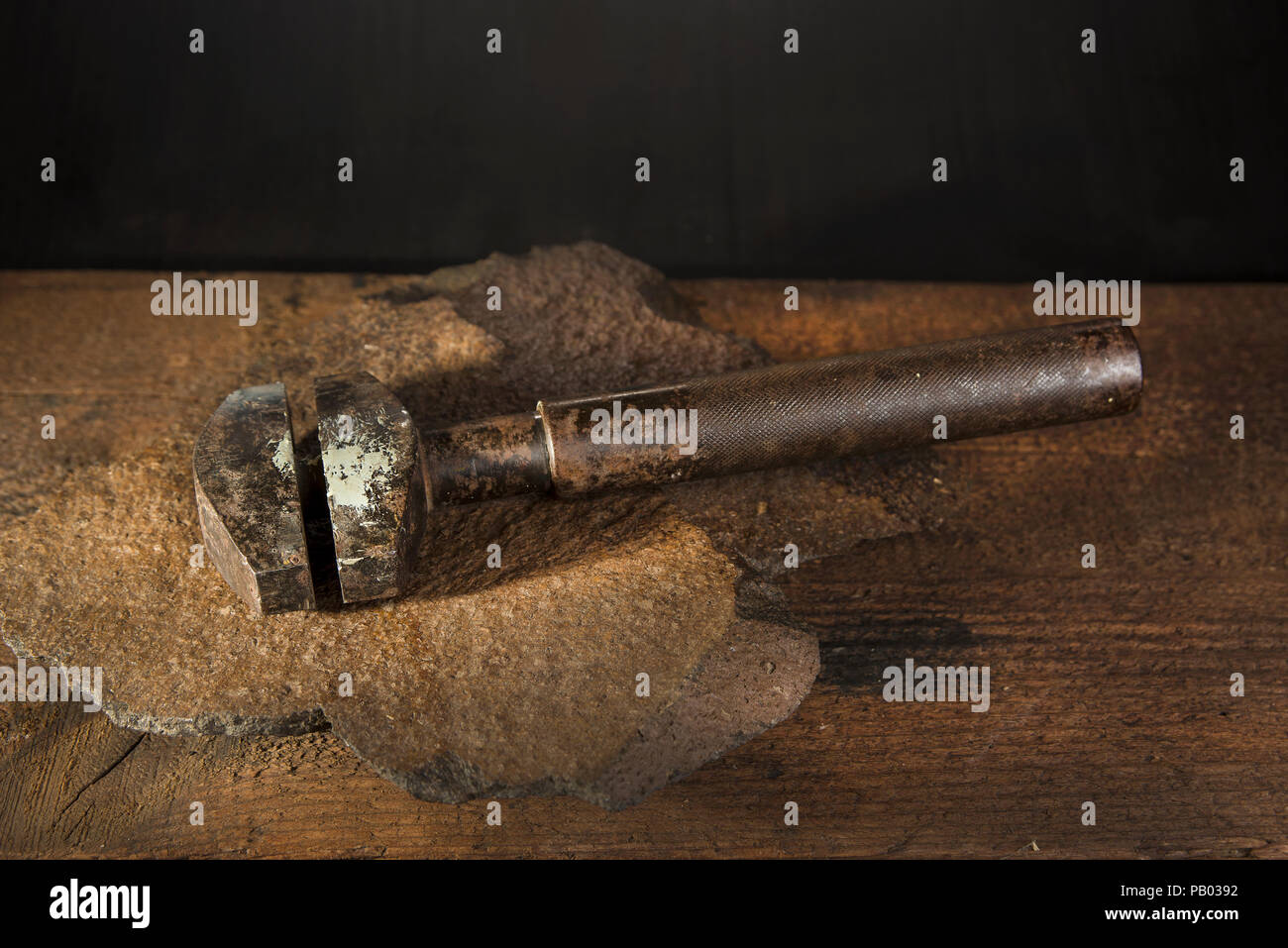 Tool french wrench on the stone and dark background Stock Photo - Alamy