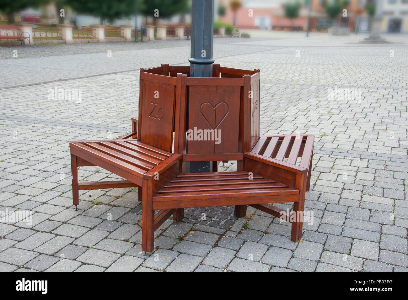 Wooden seats at the town square in the summer Stock Photo - Alamy