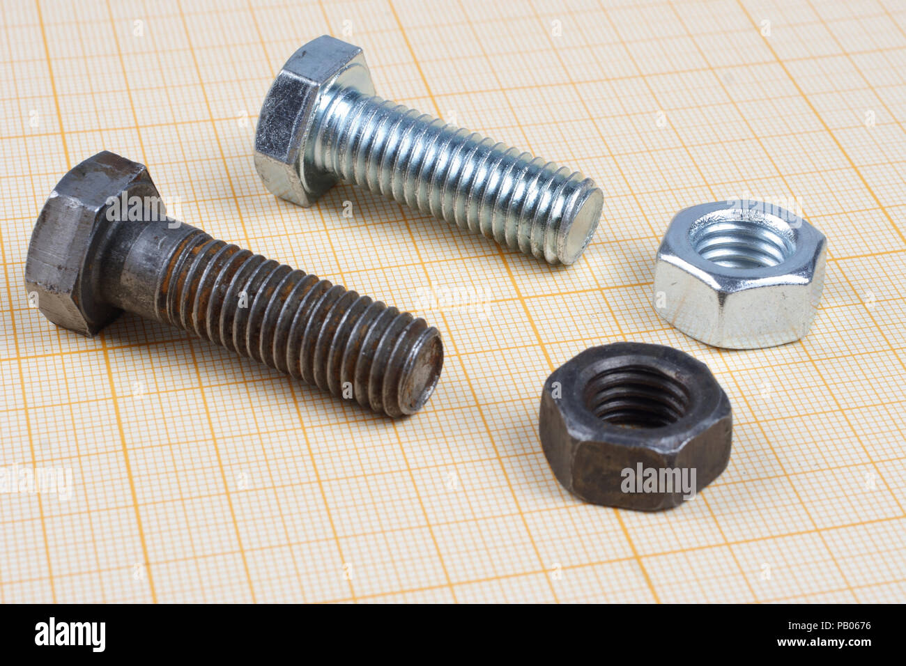 Screw, Nuts on graph paper background Stock Photo - Alamy