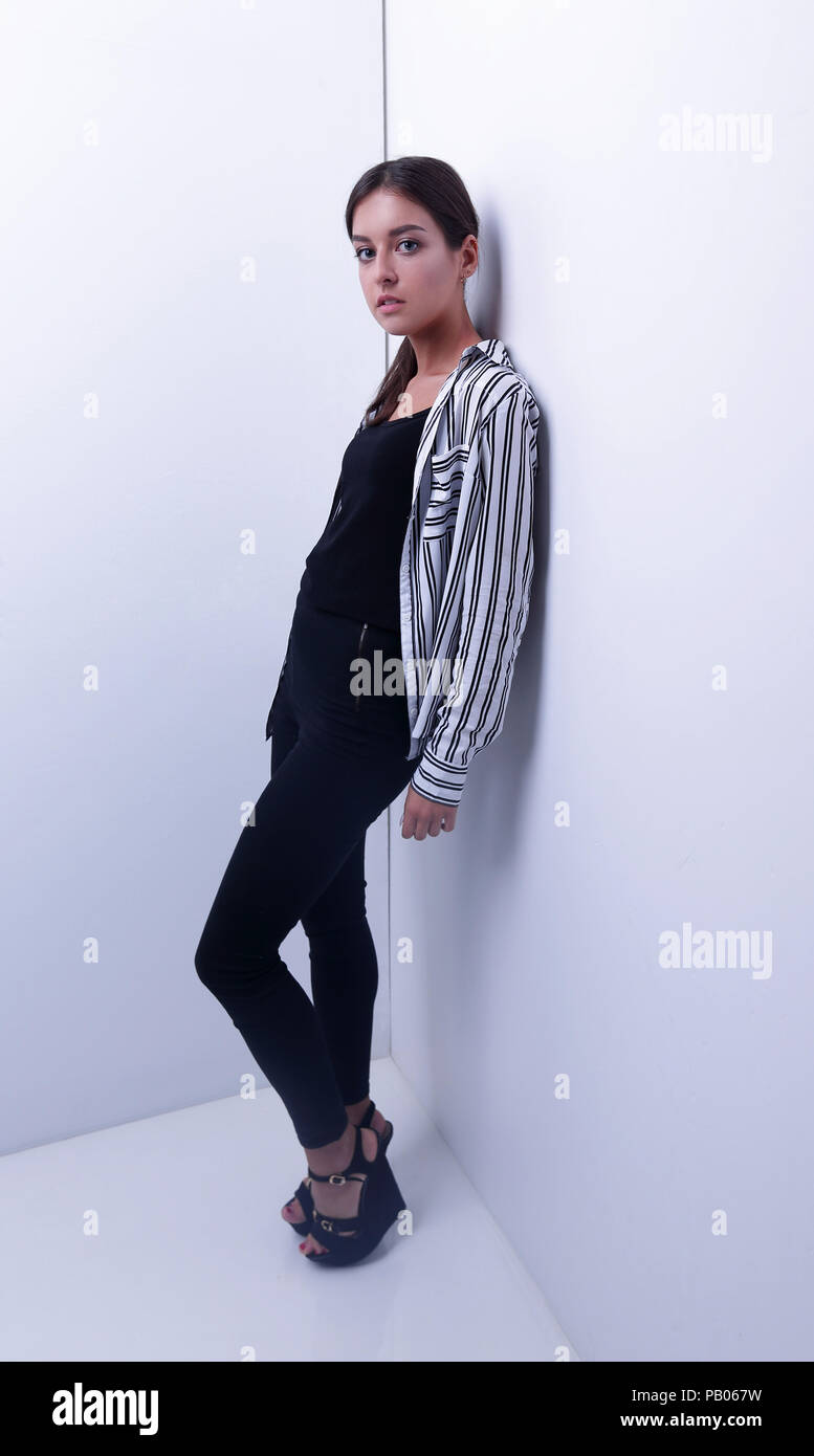 young woman leaning on wall Stock Photo - Alamy