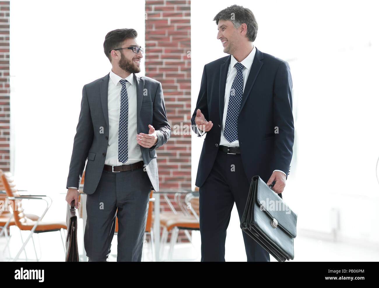 business partners walking down in office building and talking Stock ...