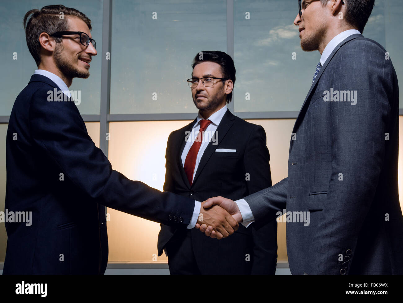 Three business shake hands hi-res stock photography and images - Alamy