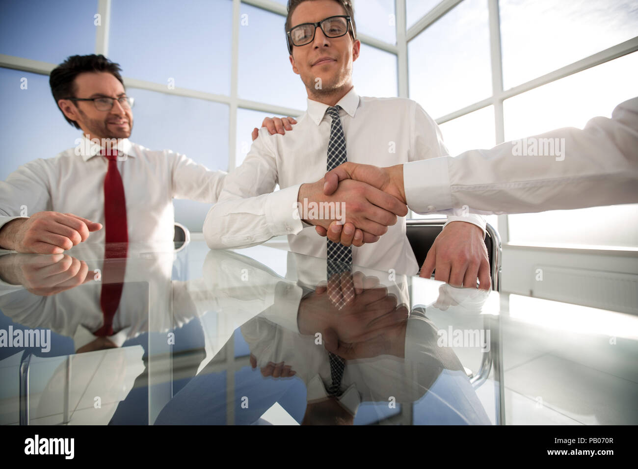 business handshake at the office Desk Stock Photo - Alamy