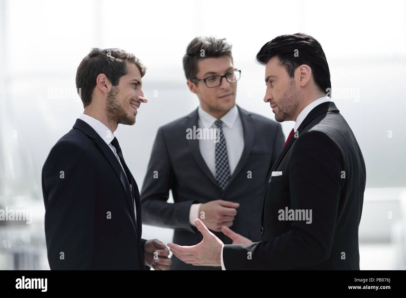 three serious businessmen discussing the problems Stock Photo - Alamy