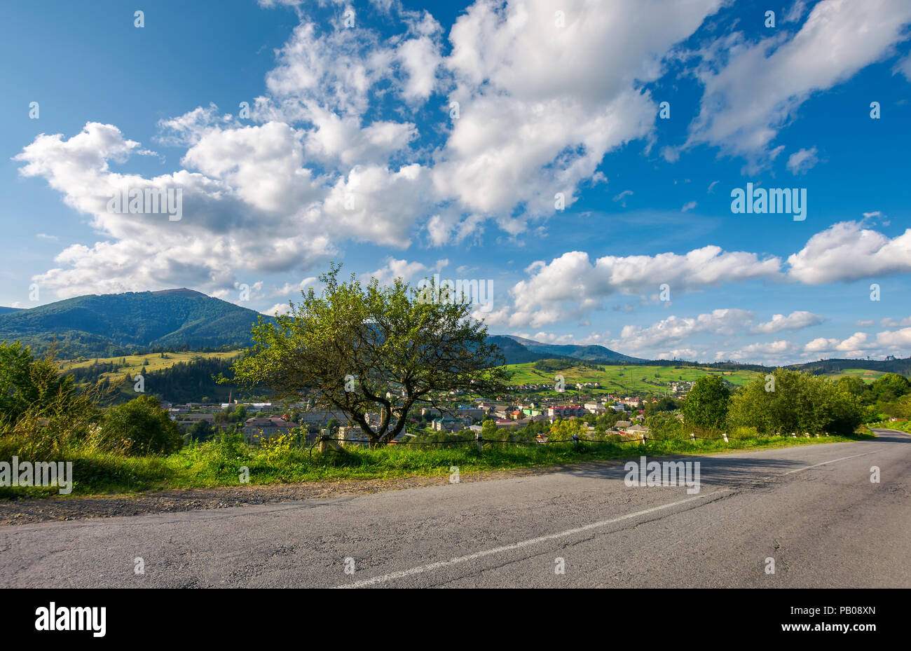 road through beautiful countryside. town in the valley at the foot of ...