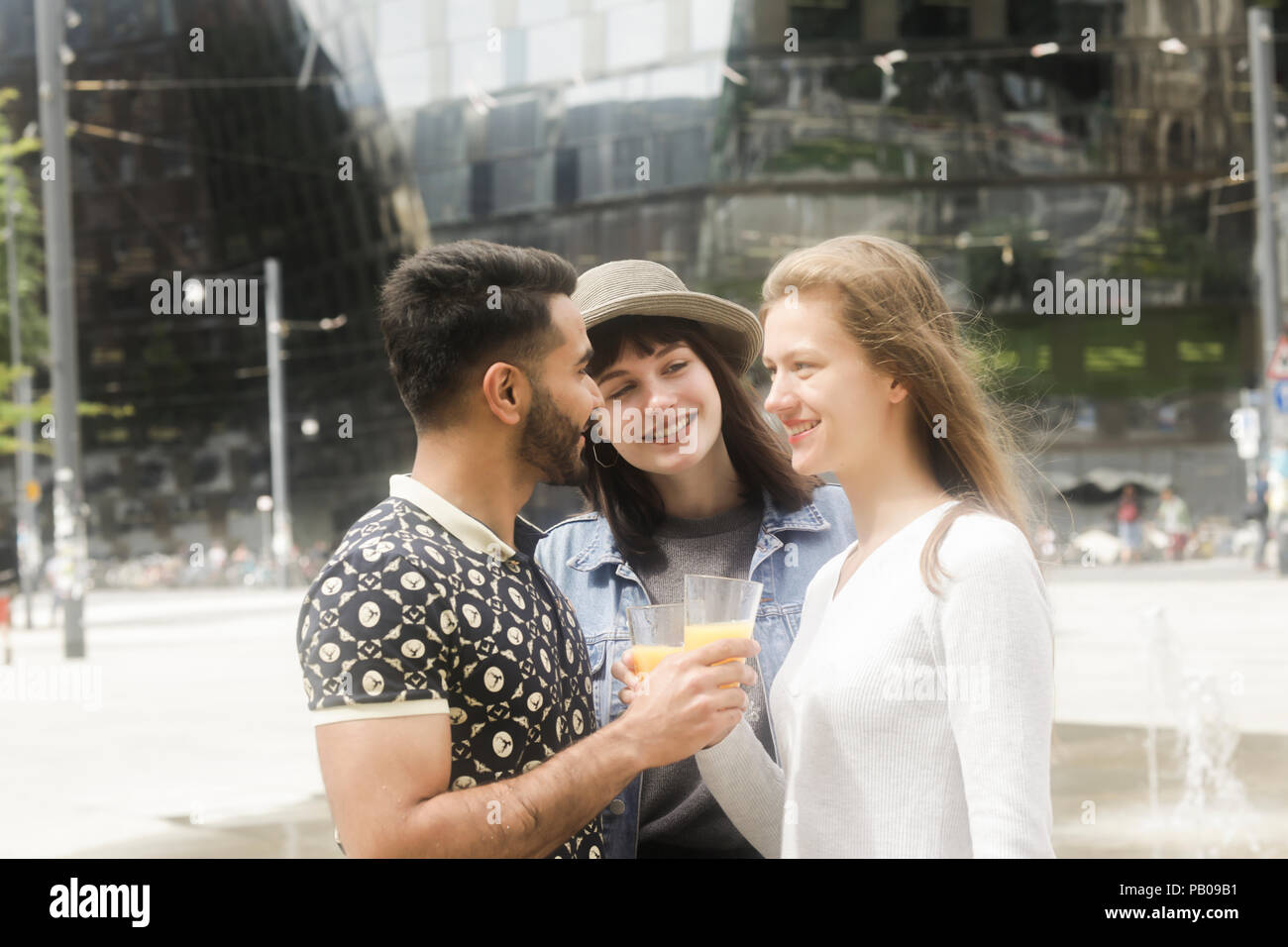 Three smiling friends making a celebratory toast Stock Photo - Alamy