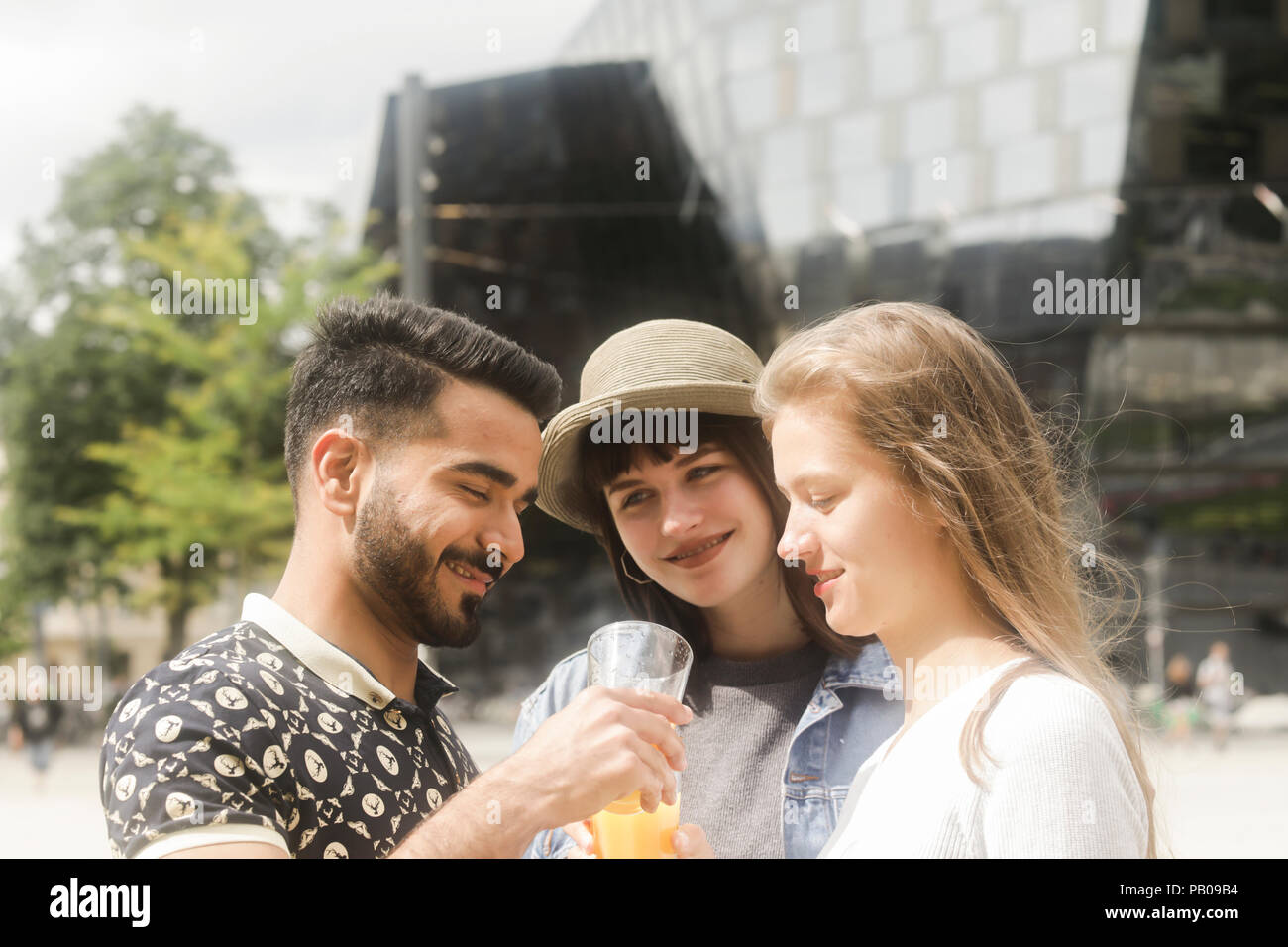 Three smiling friends making a celebratory toast Stock Photo - Alamy