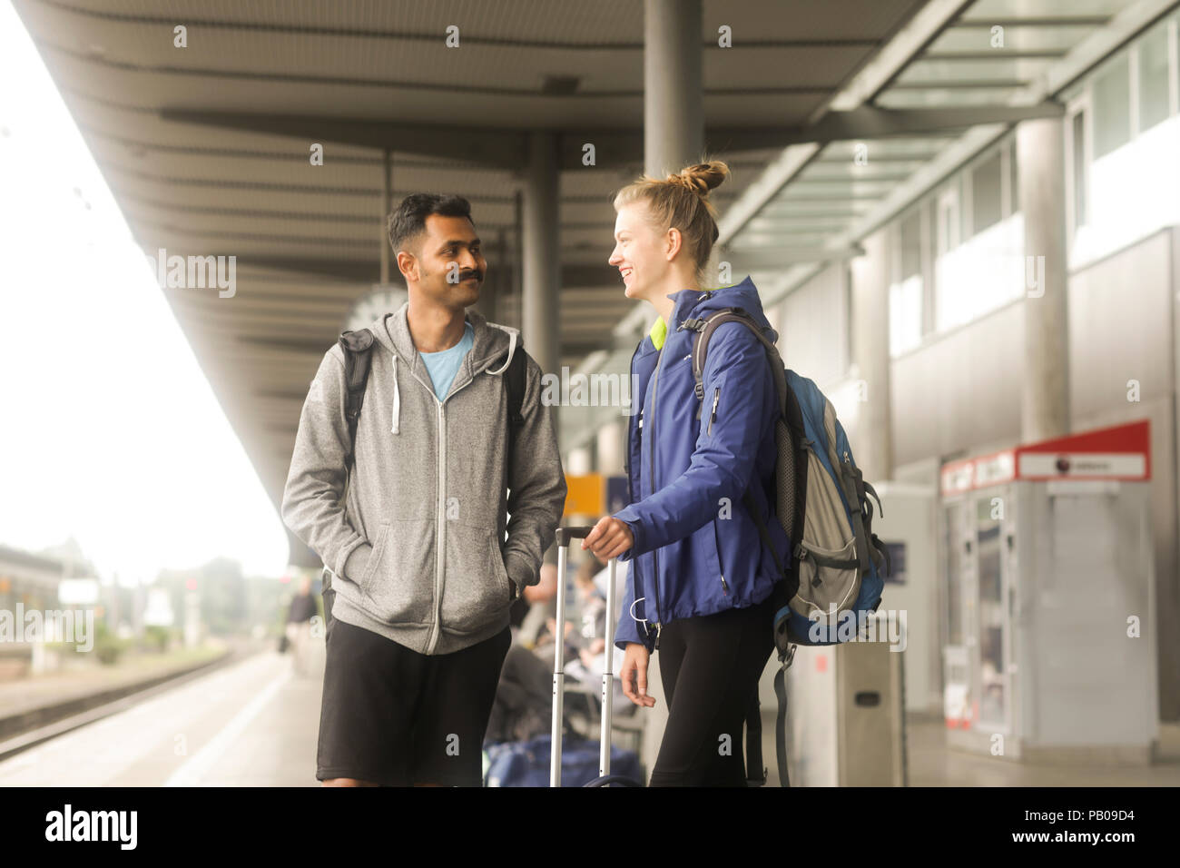 Couple standing on a railway station platform waiting for a train Stock ...