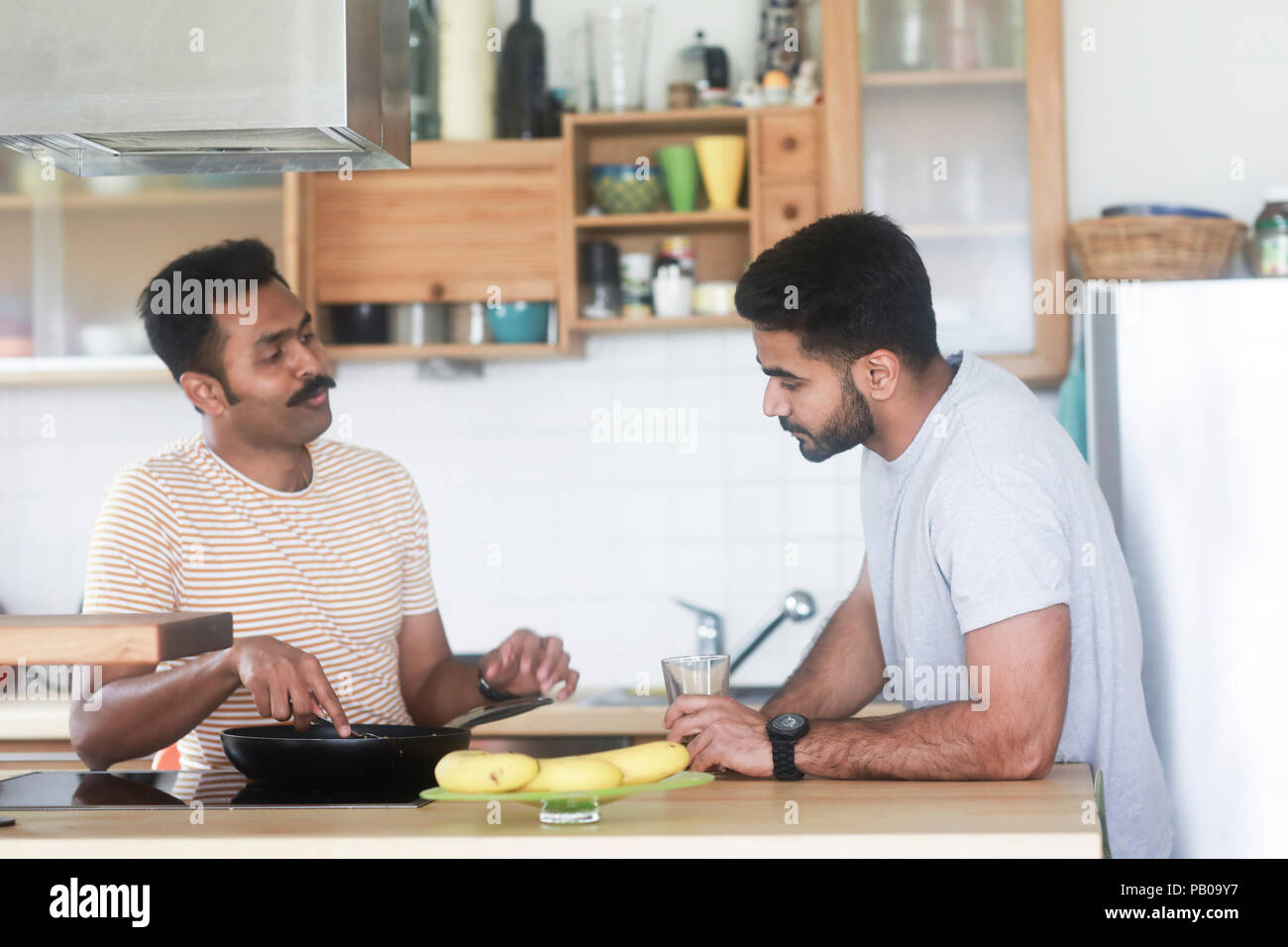 Two men preparing dinner Stock Photo - Alamy