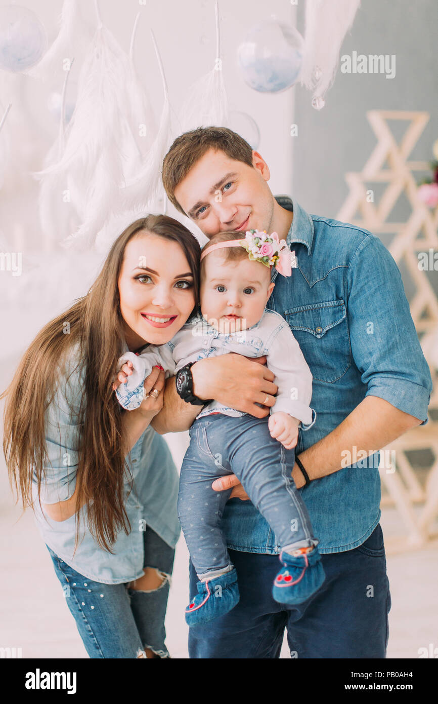 The lovely vertical portrait of the smiling parent holding their ...