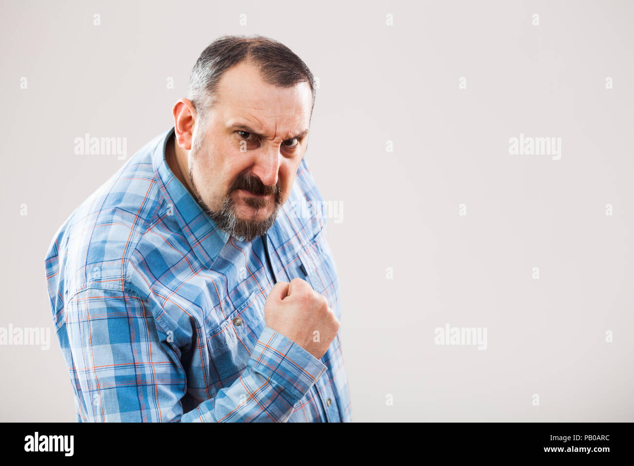 Portrait of angry man who threatens Stock Photo - Alamy