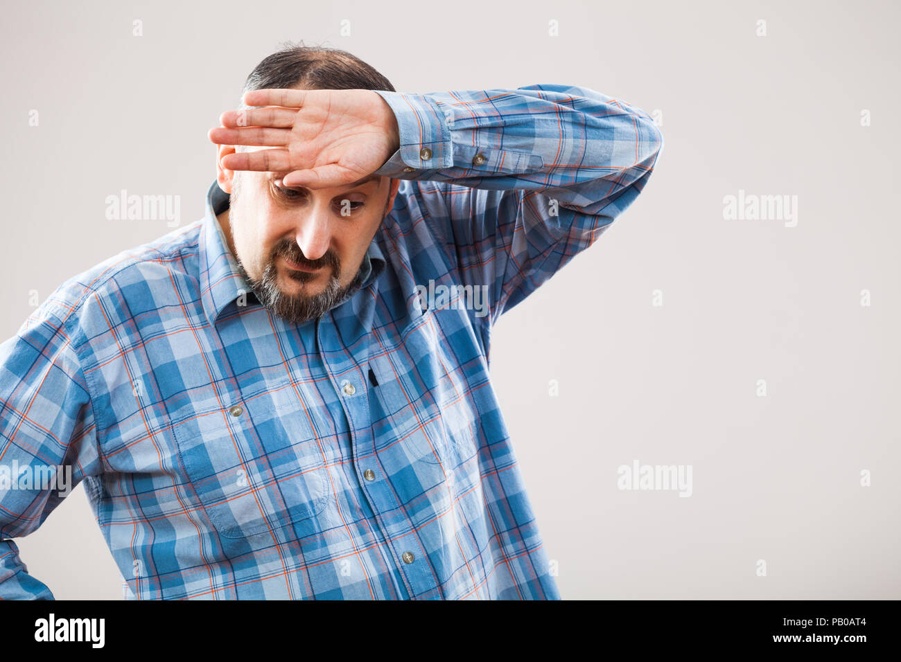 Studio shot portrait of tired and exhausted man Stock Photo - Alamy