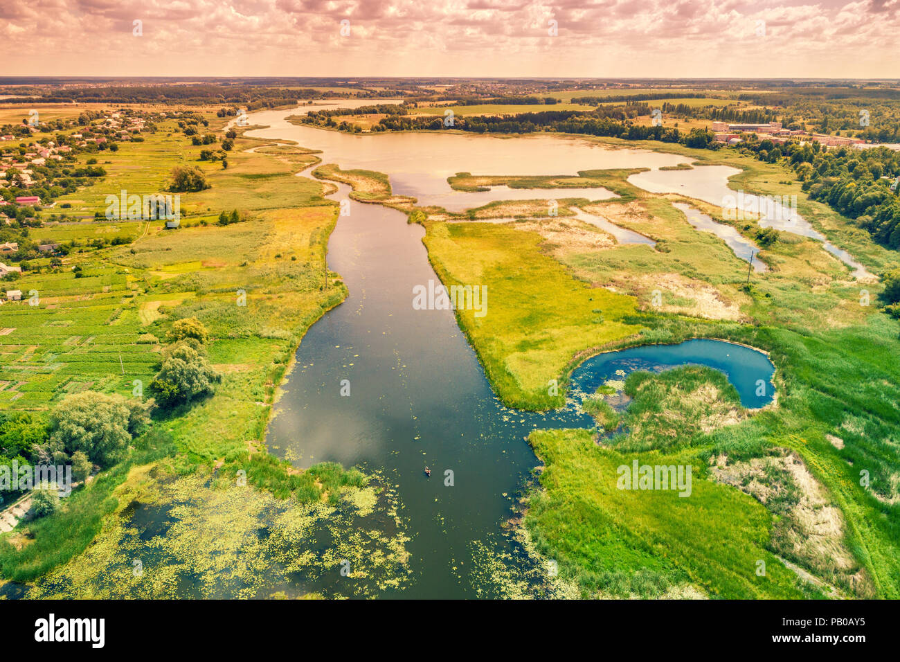 Aerial view of countryside and lake in evening Stock Photo - Alamy