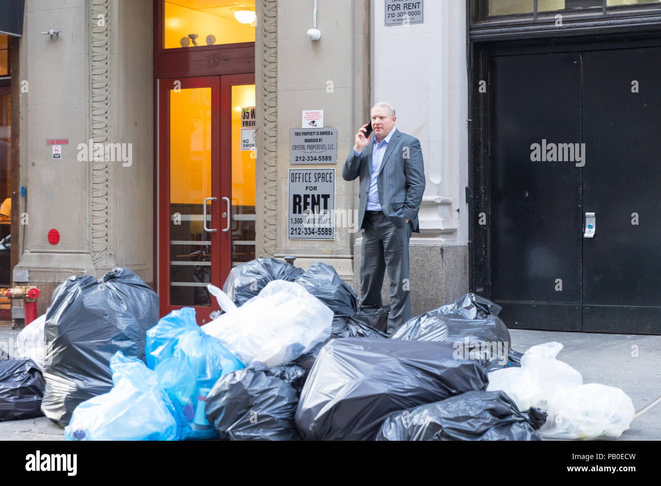 New York, United States, July 19, 2018: Businessmen Walk Call Phone ...