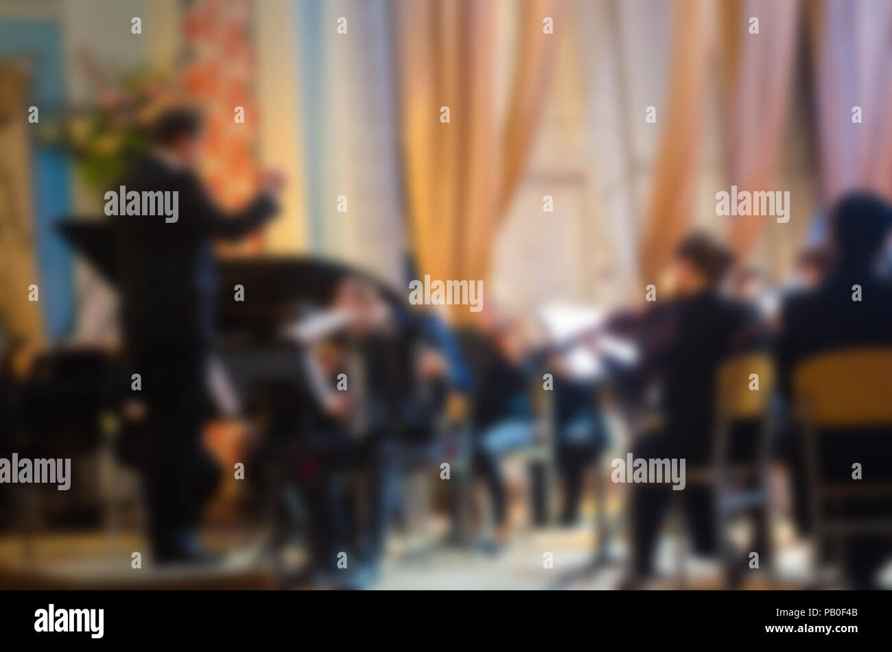 Orchestra conductor manages the orchestra. musical concept. blurred ...