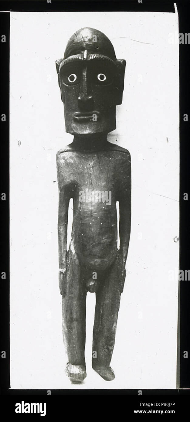 A wooden moai kavakava anthropomorphic figure carving with obsidian ...