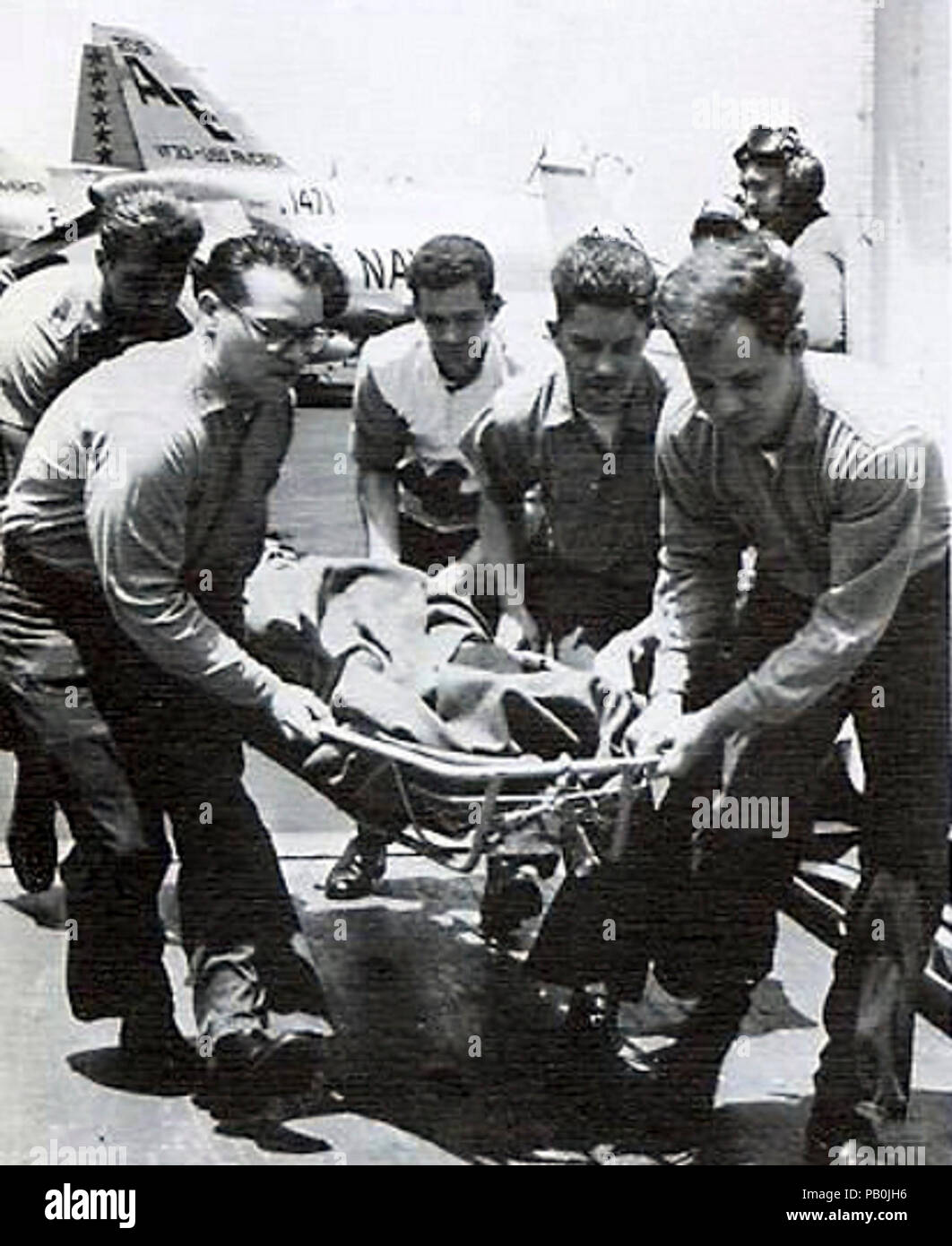 A wounded crewmen of USS Liberty (AGTR-5) is carried on the flight deck ...