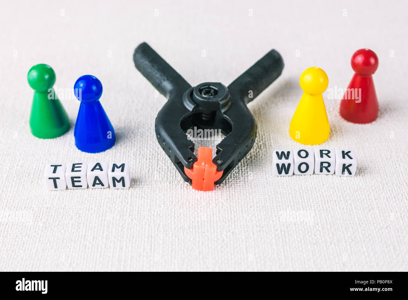 Team work concept - Figures form with clamp tool as symbol for a ...