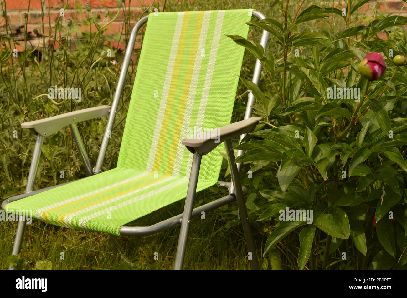 camping chair is set in the garden on the grass Stock Photo - Alamy