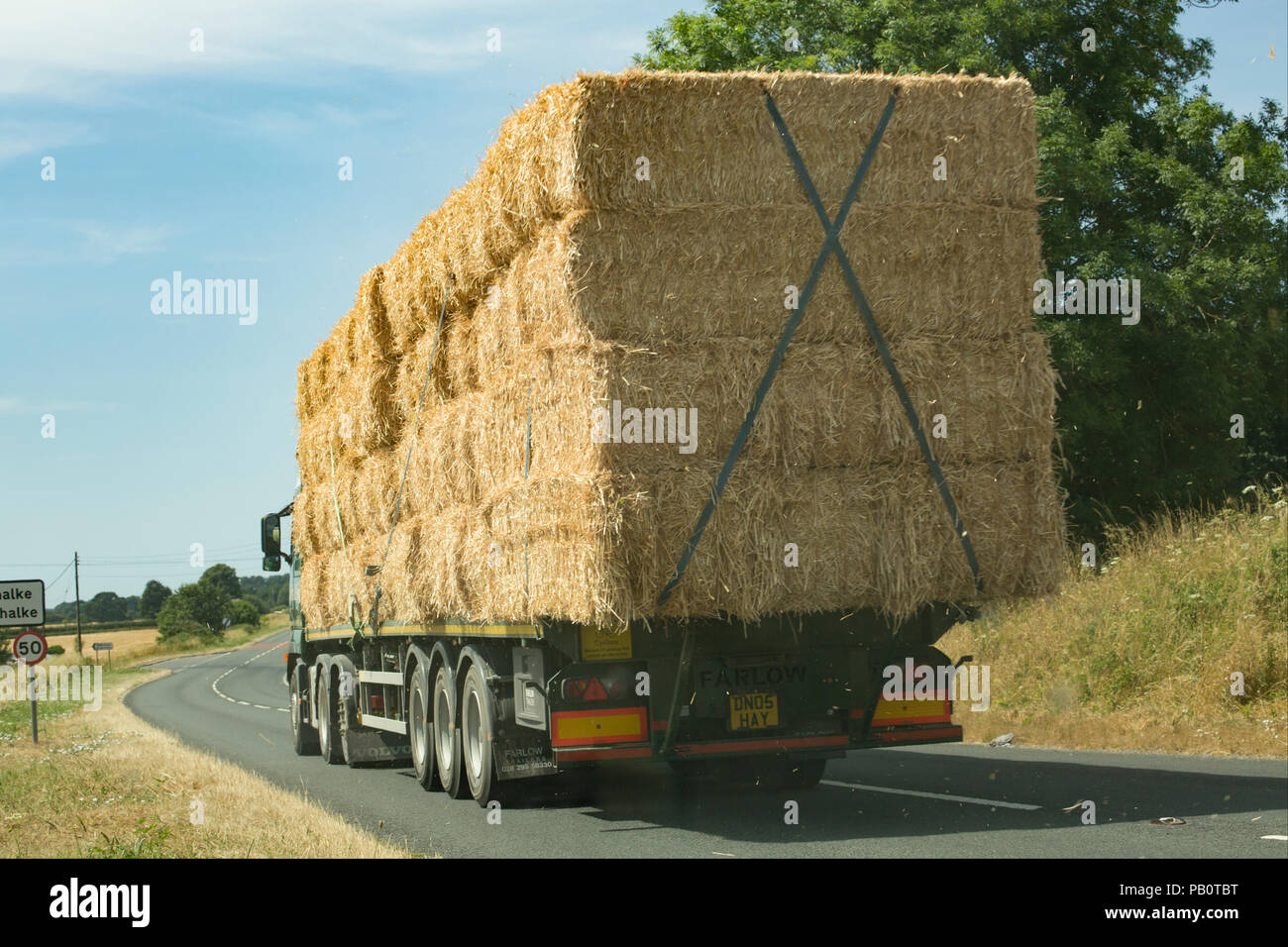 A lorry carrying straw bales on the A30 road during the UK 2018 ...
