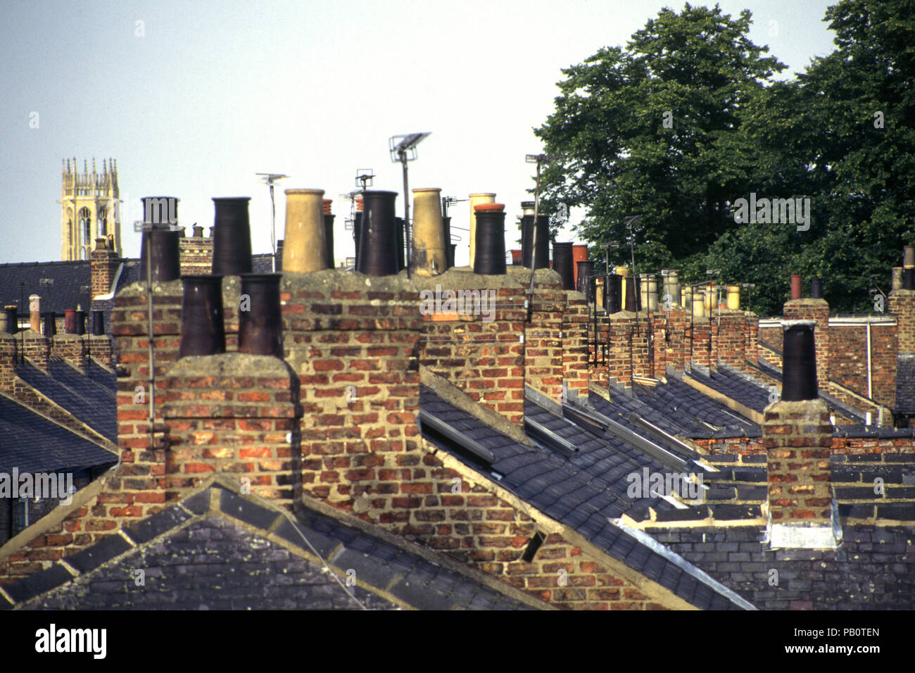 Old Victorian terraced house chimney stacks and chimney pots in lines ...