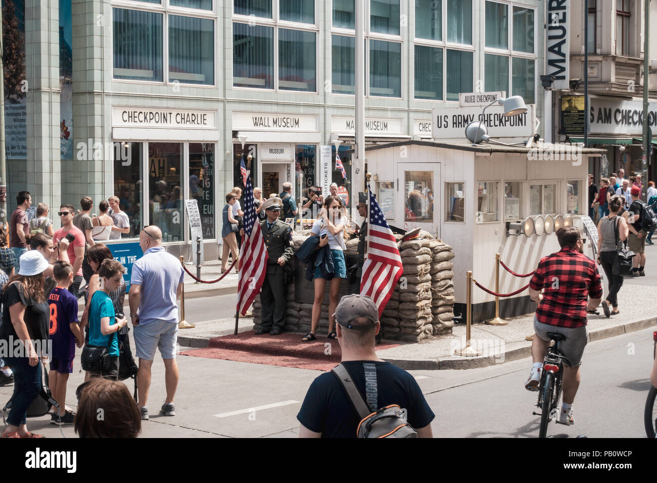 People visiting Checkpoint Charlie, making photographs with American ...