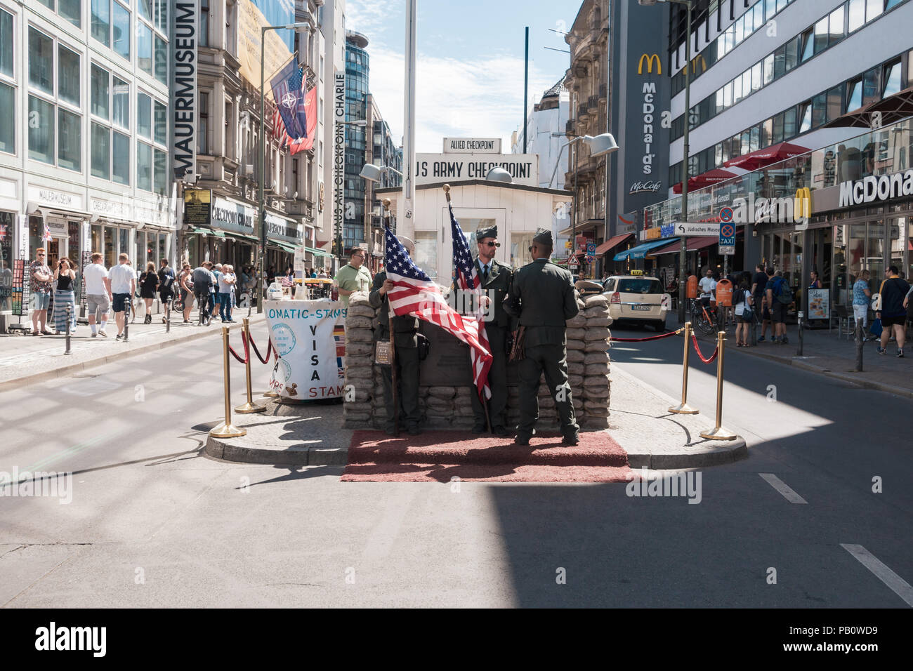 People visiting Checkpoint Charlie, making photographs with American ...