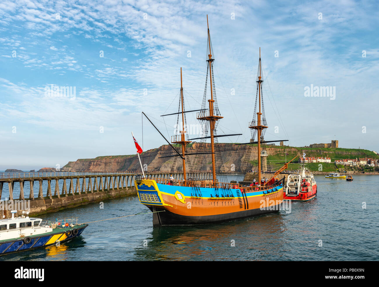 A replica of the HMS Bark Endeavour entering Whitby harbour Stock Photo ...