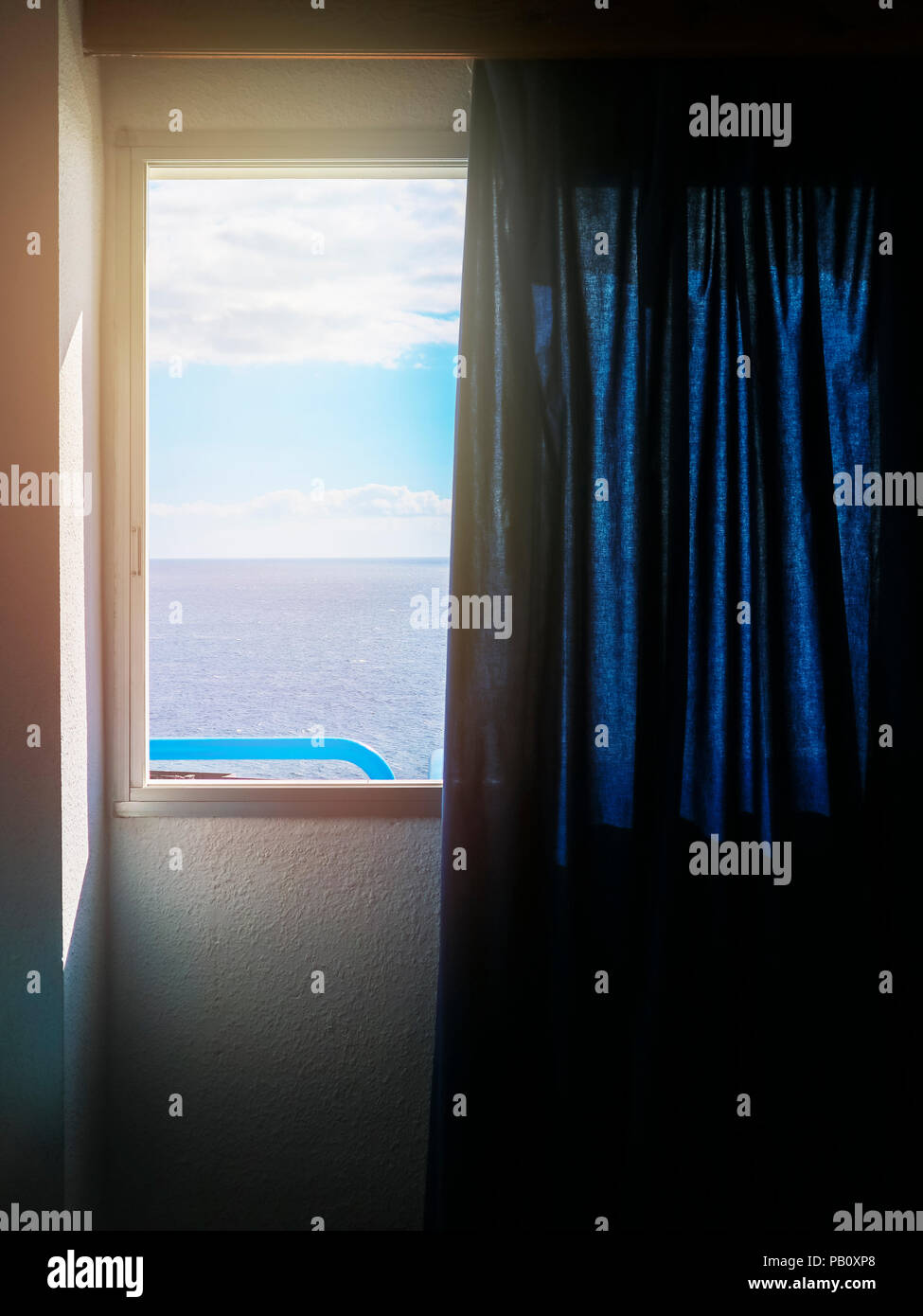 View from the window of hotel room, blue curtain, bright sunshine ...