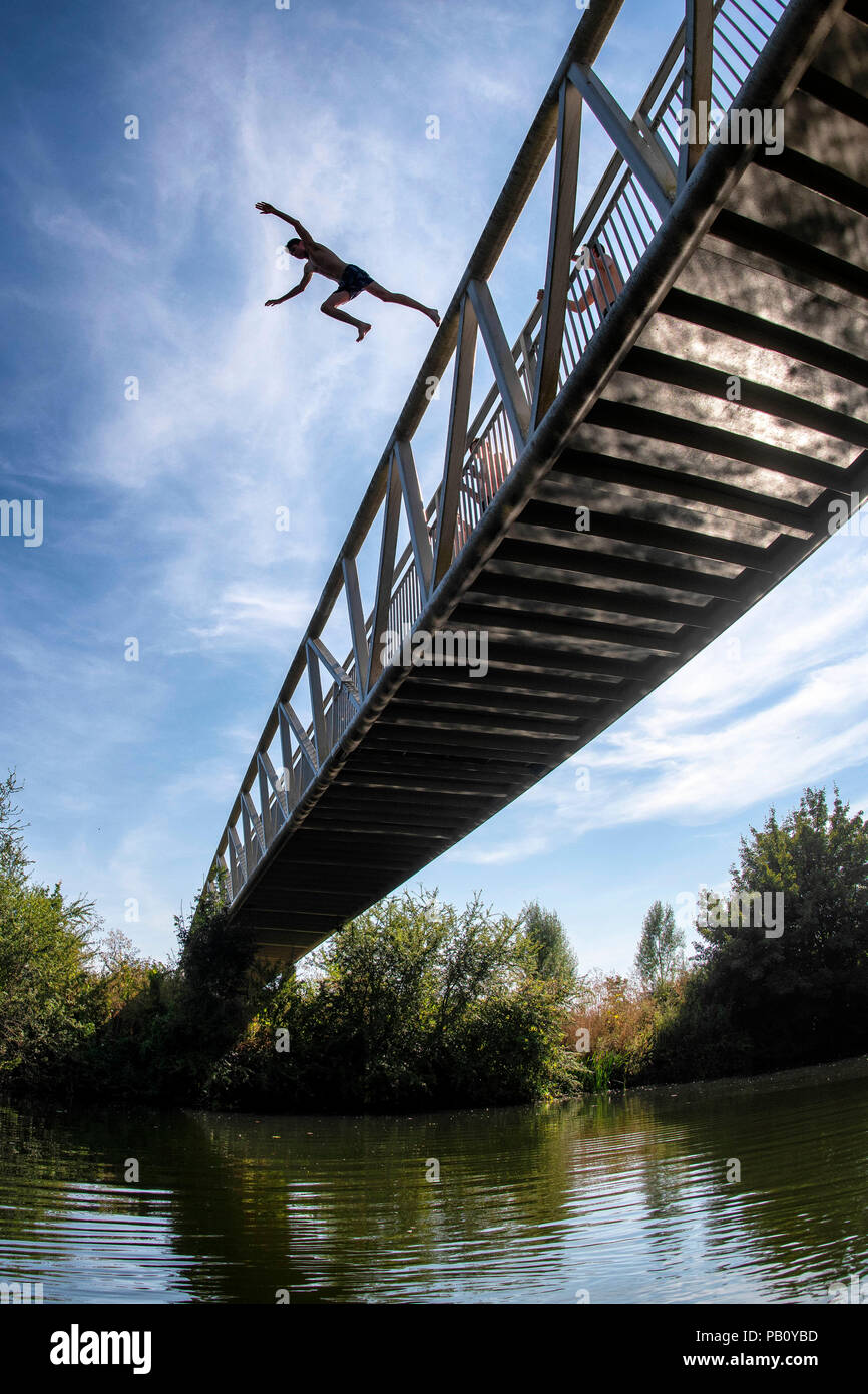 Boy jumping across water hi-res stock photography and images - Alamy