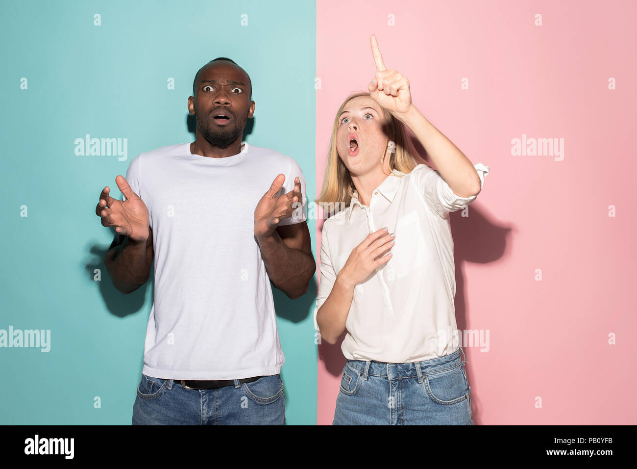 Portrait of the scared man and woman on pink and blue Stock Photo - Alamy